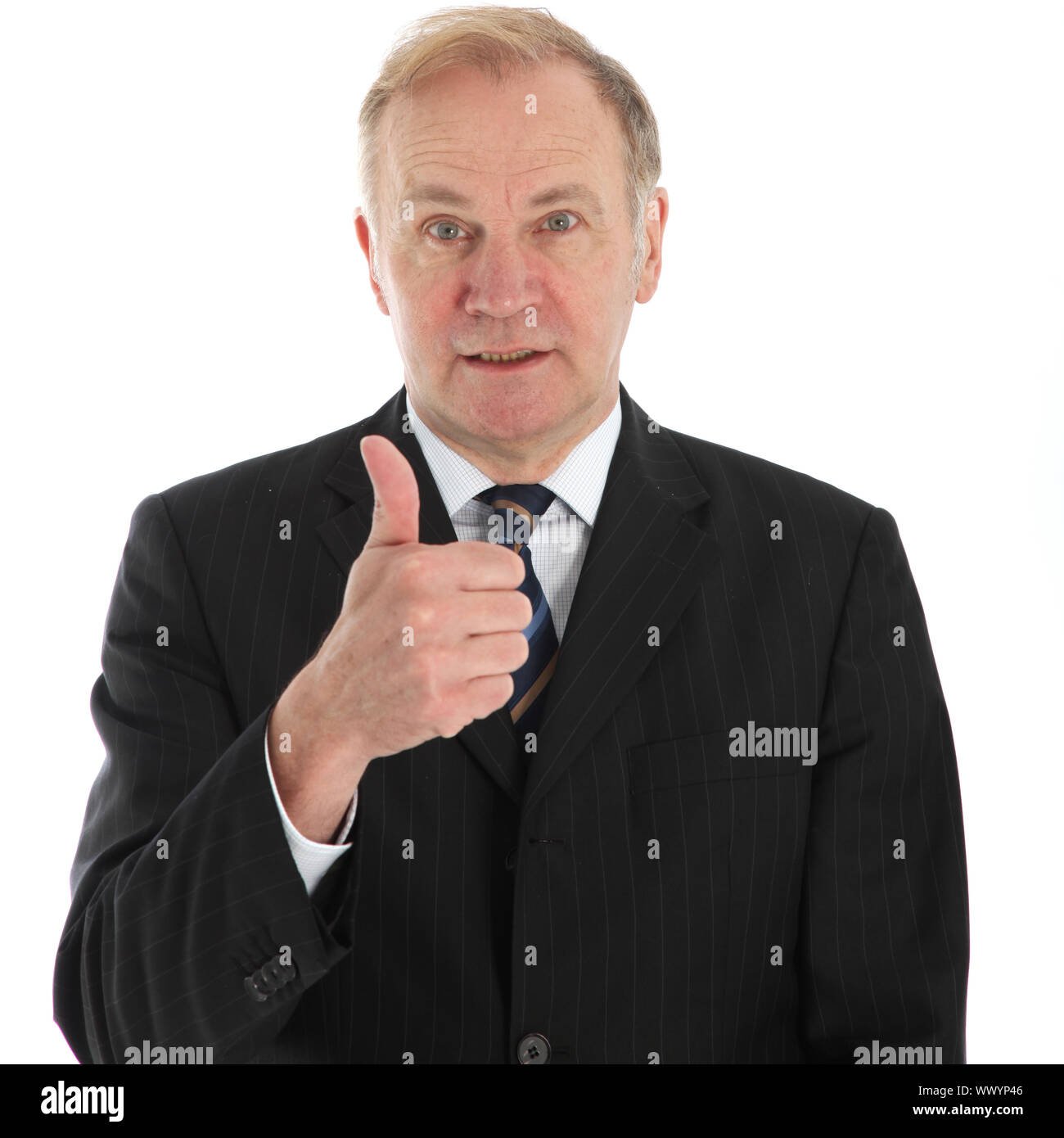 Elderly businessman giving a thumbs up gesture of agreement and ...