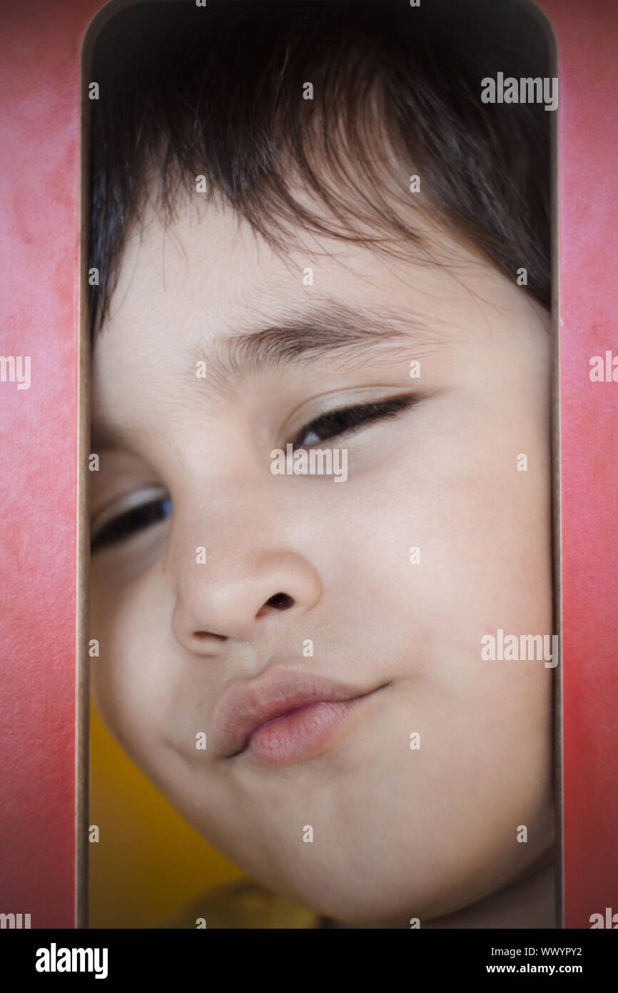 Brunette boy putting funny faces in an outdoor park Stock Photo - Alamy