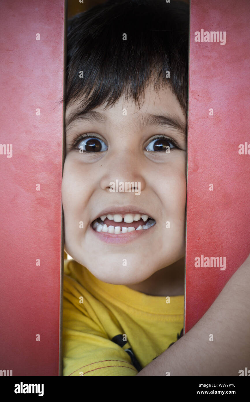 Brunette boy putting funny faces in an outdoor park Stock Photo - Alamy