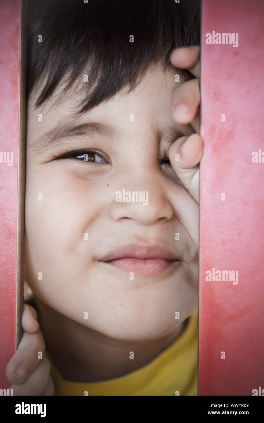 Brunette boy putting funny faces in an outdoor park Stock Photo - Alamy