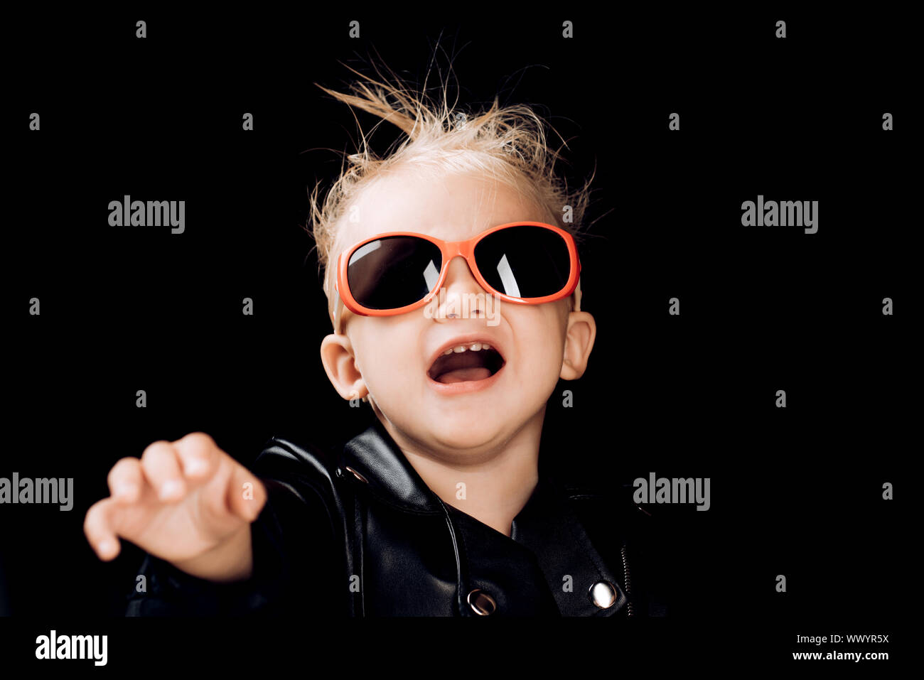 Stay wild and free. Little child boy in rocker jacket and sunglasses ...