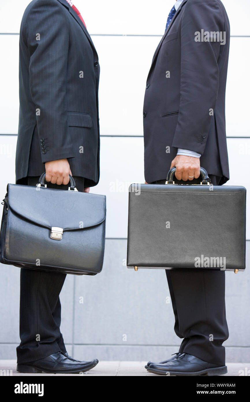 Two businessmen holding briefcases hi-res stock photography and images ...