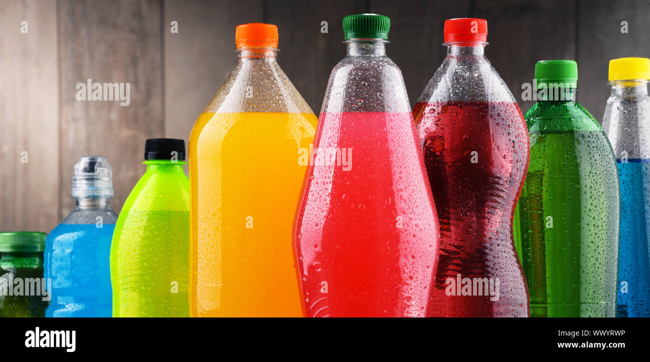 Plastic bottles of assorted carbonated soft drinks in variety of colors ...