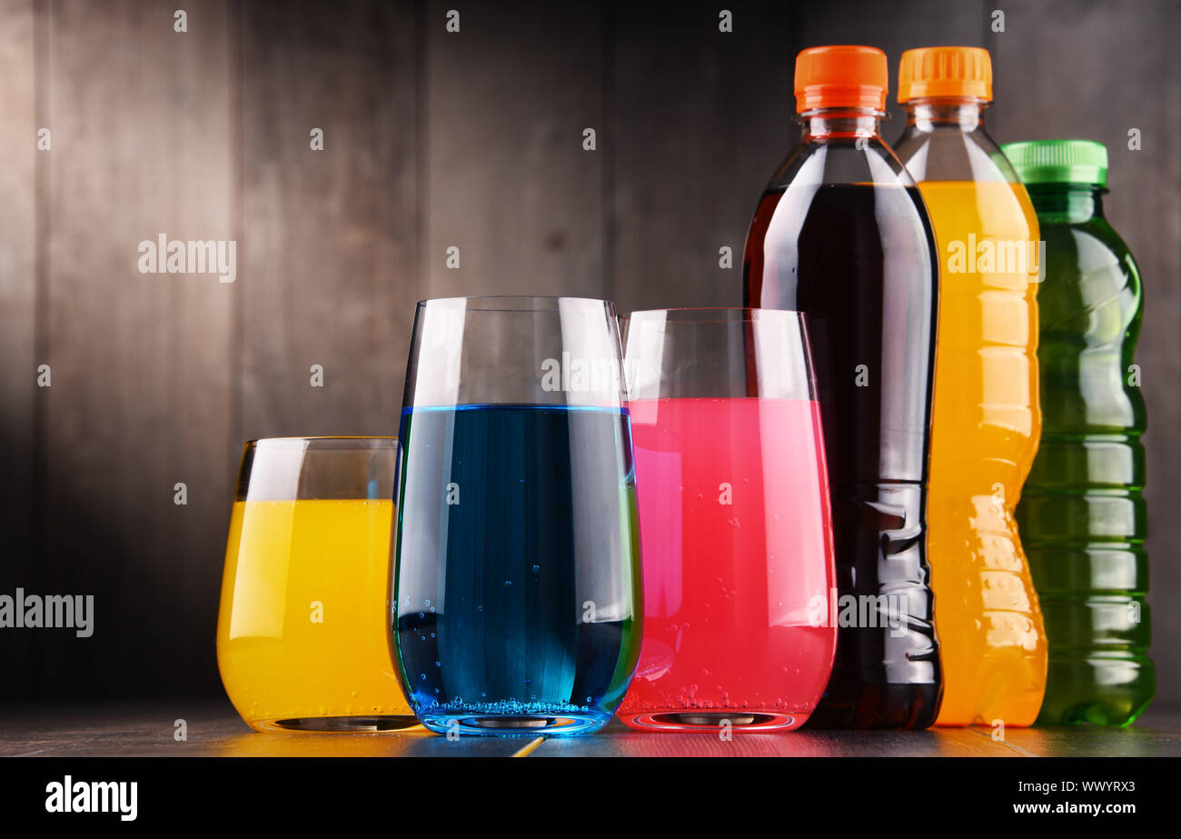 Glasses and bottles of assorted carbonated soft drinks in variety of ...