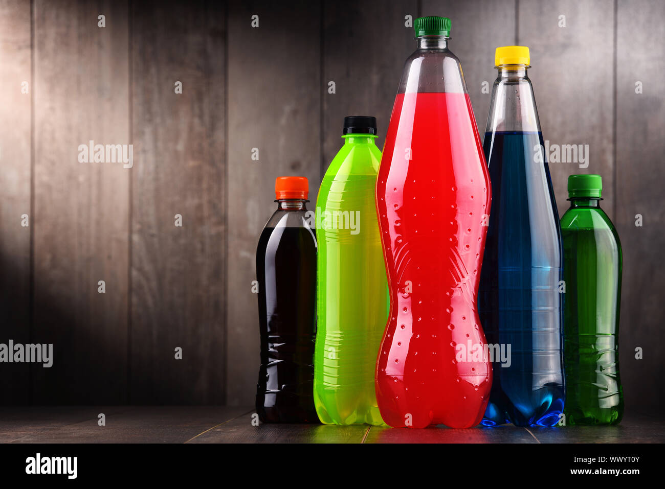 Plastic bottles of assorted carbonated soft drinks in variety of colors ...