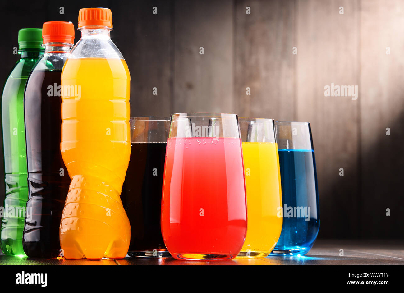 Glasses and bottles of assorted carbonated soft drinks in variety of ...