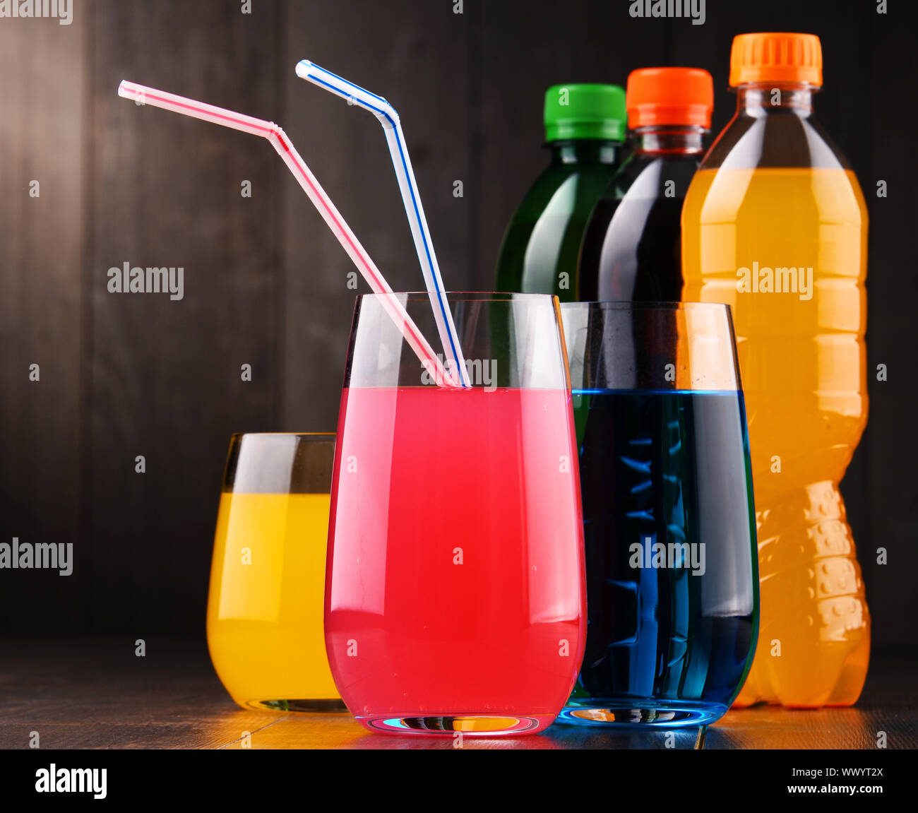 Glasses and bottles of assorted carbonated soft drinks in variety of ...