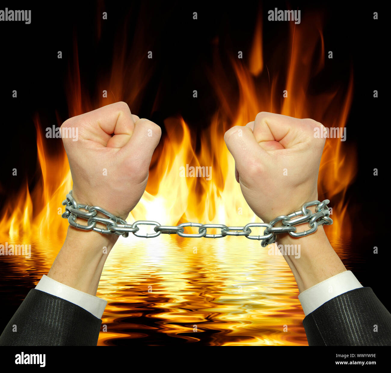 Hands in chains on a fire background Stock Photo - Alamy