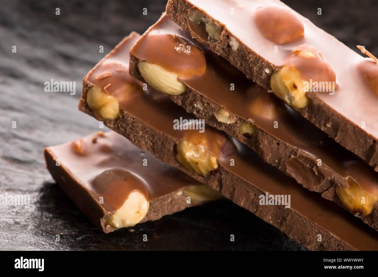 Pile of broken chocolate with nuts Stock Photo - Alamy
