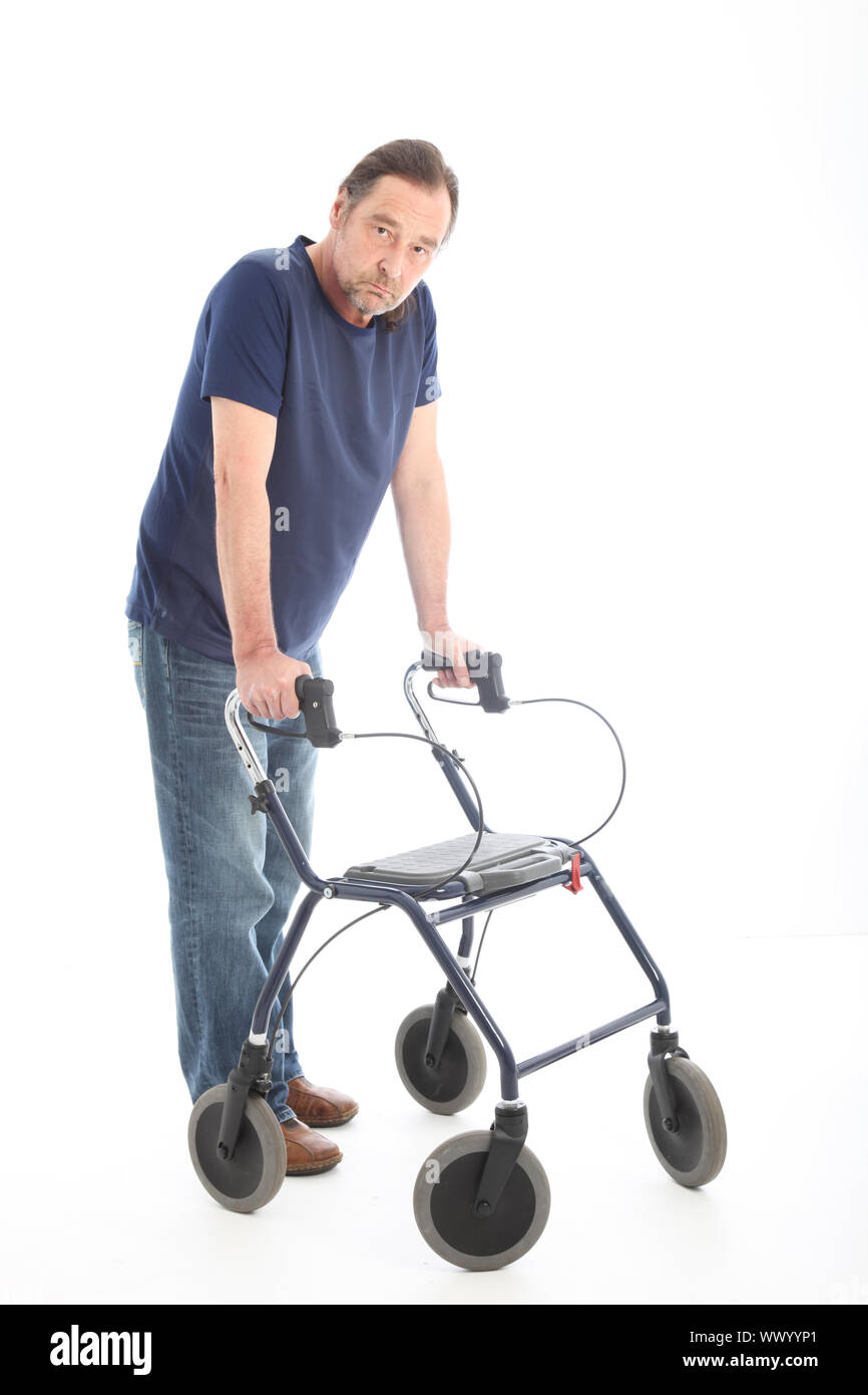 Middle-aged man walking leaning his arms and weight on a medical walker ...
