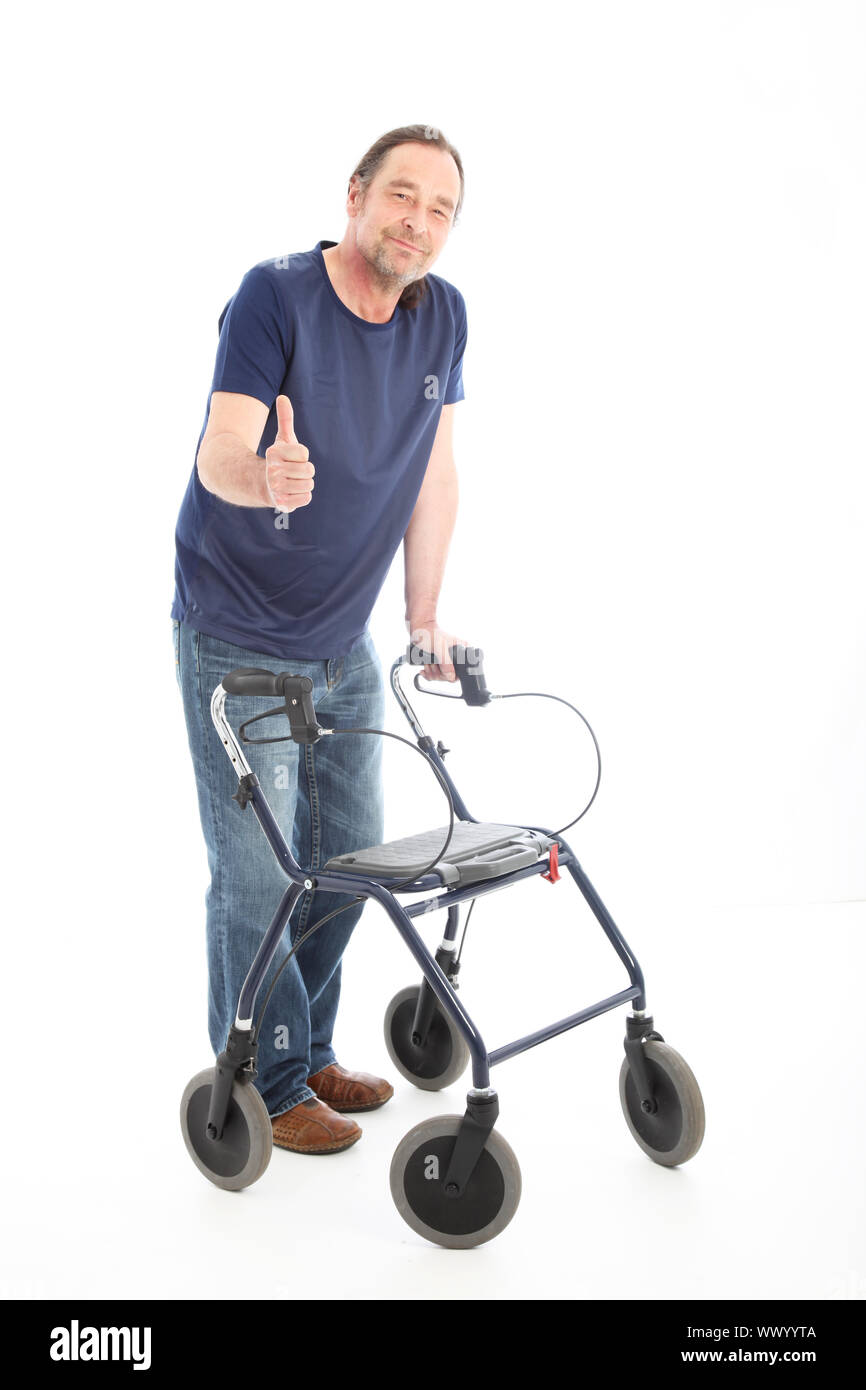 Happy male patient using a medical walker giving a thumbs up gesture to ...