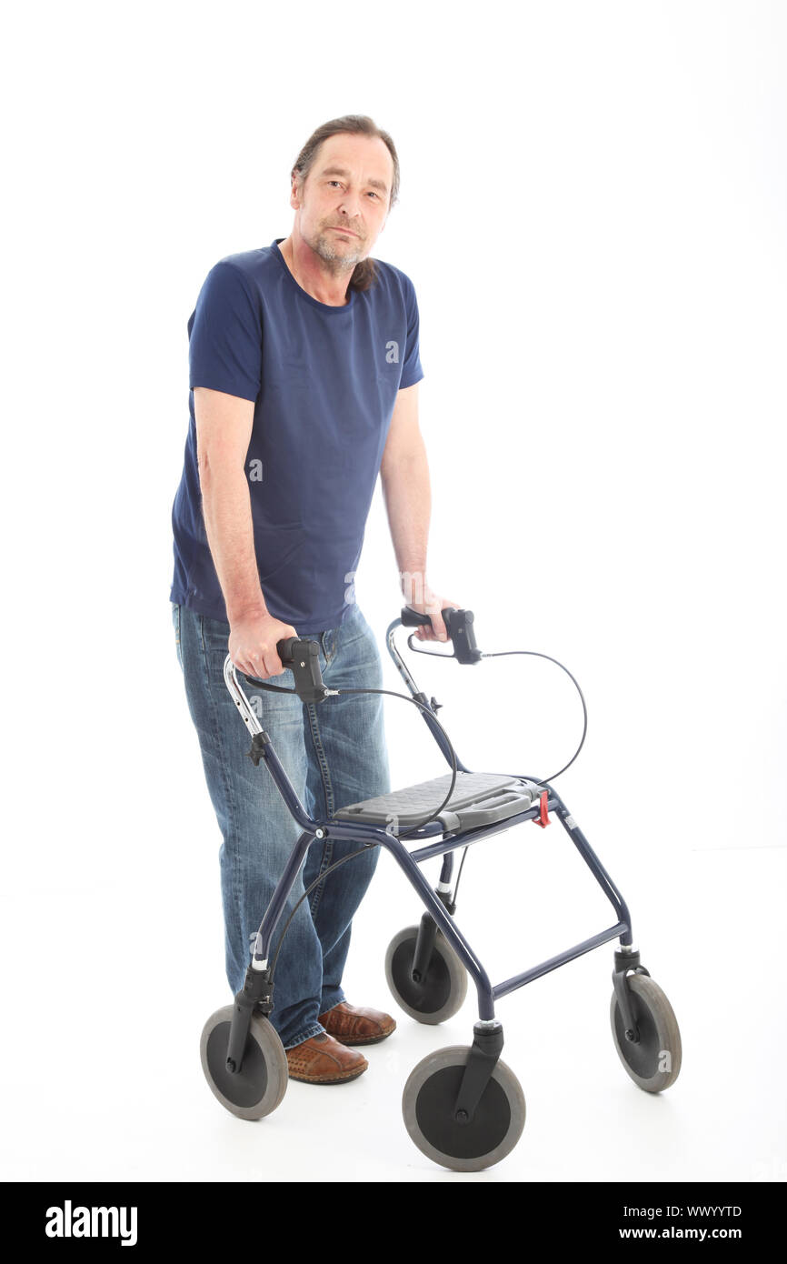 Hopeful positive man standing leaning his weight on a health walker for ...