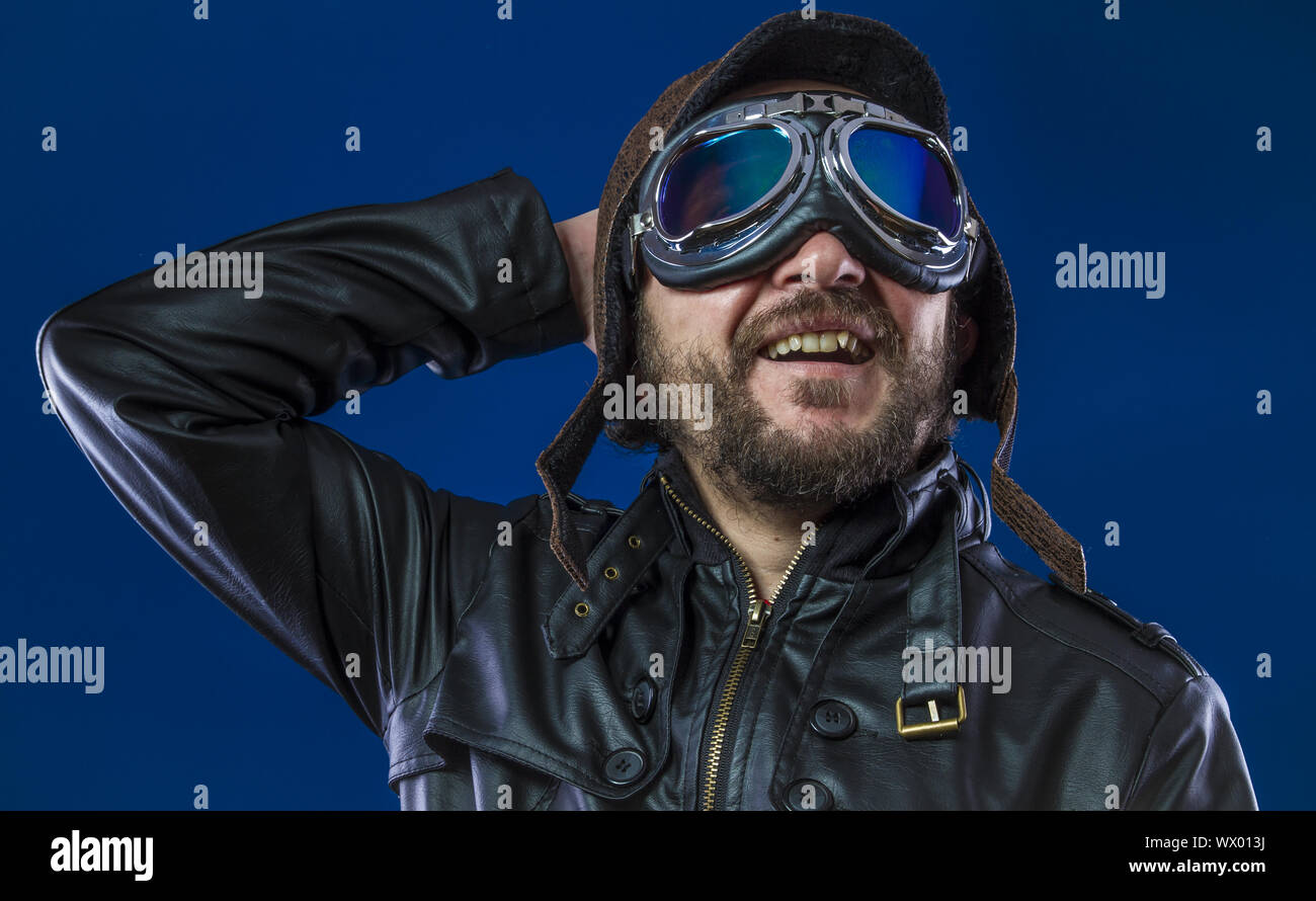 Proud, pilot of the 20s with sunglasses and vintage aviator helmet ...