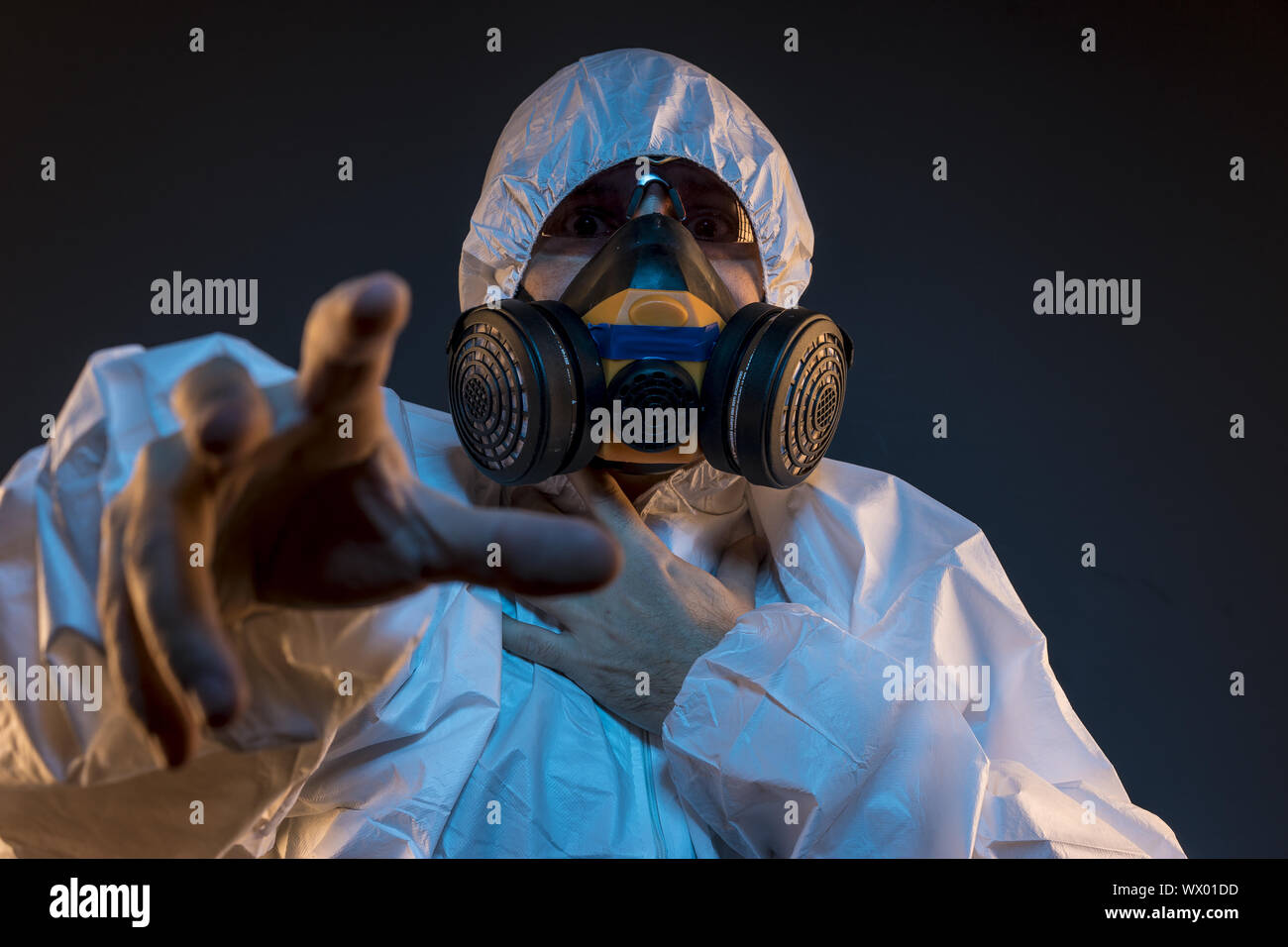 virus infection concept. Man in protective suit and antigas mask with ...