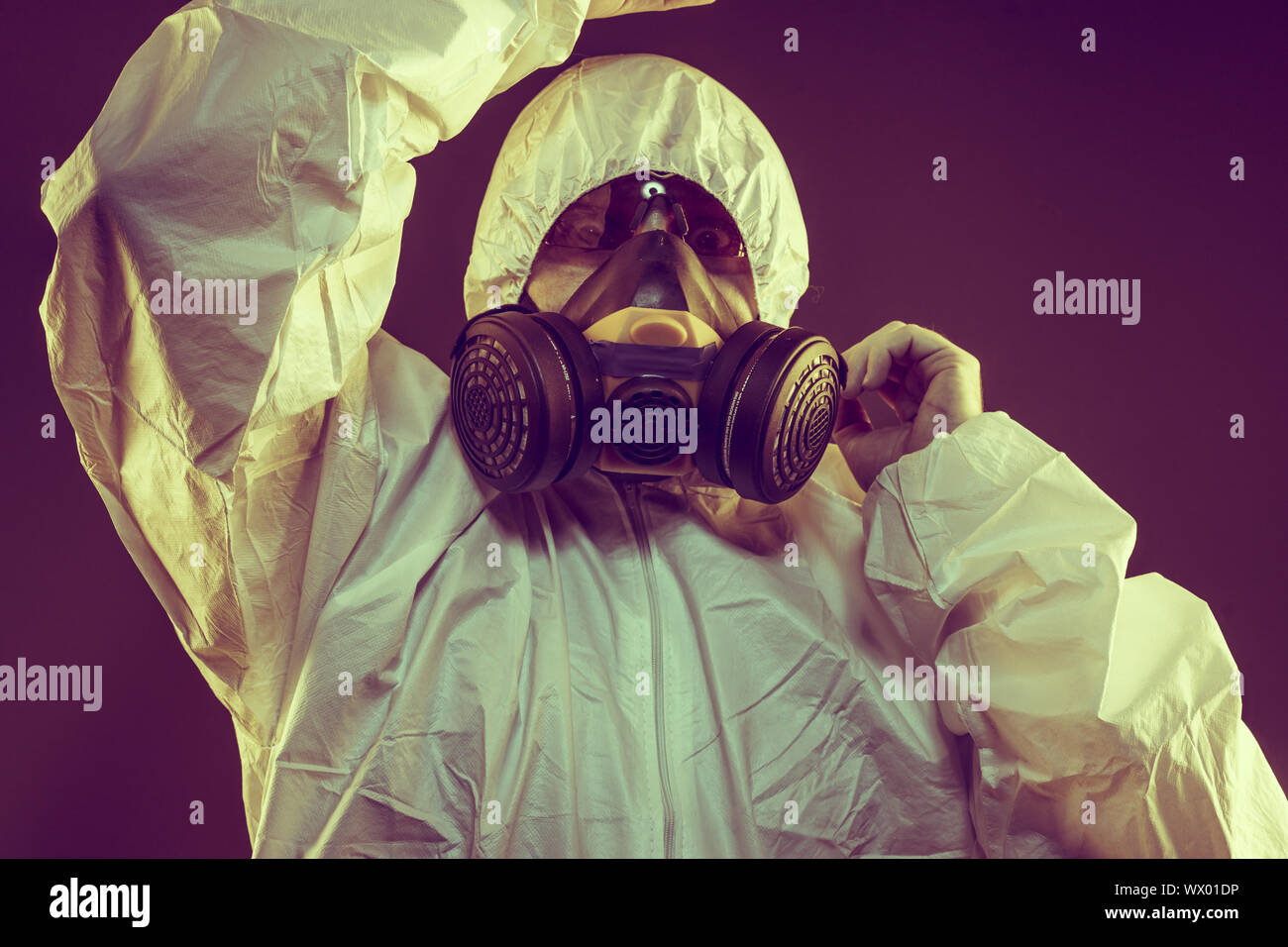 Contagious virus infection concept. Man in protective suit and antigas ...