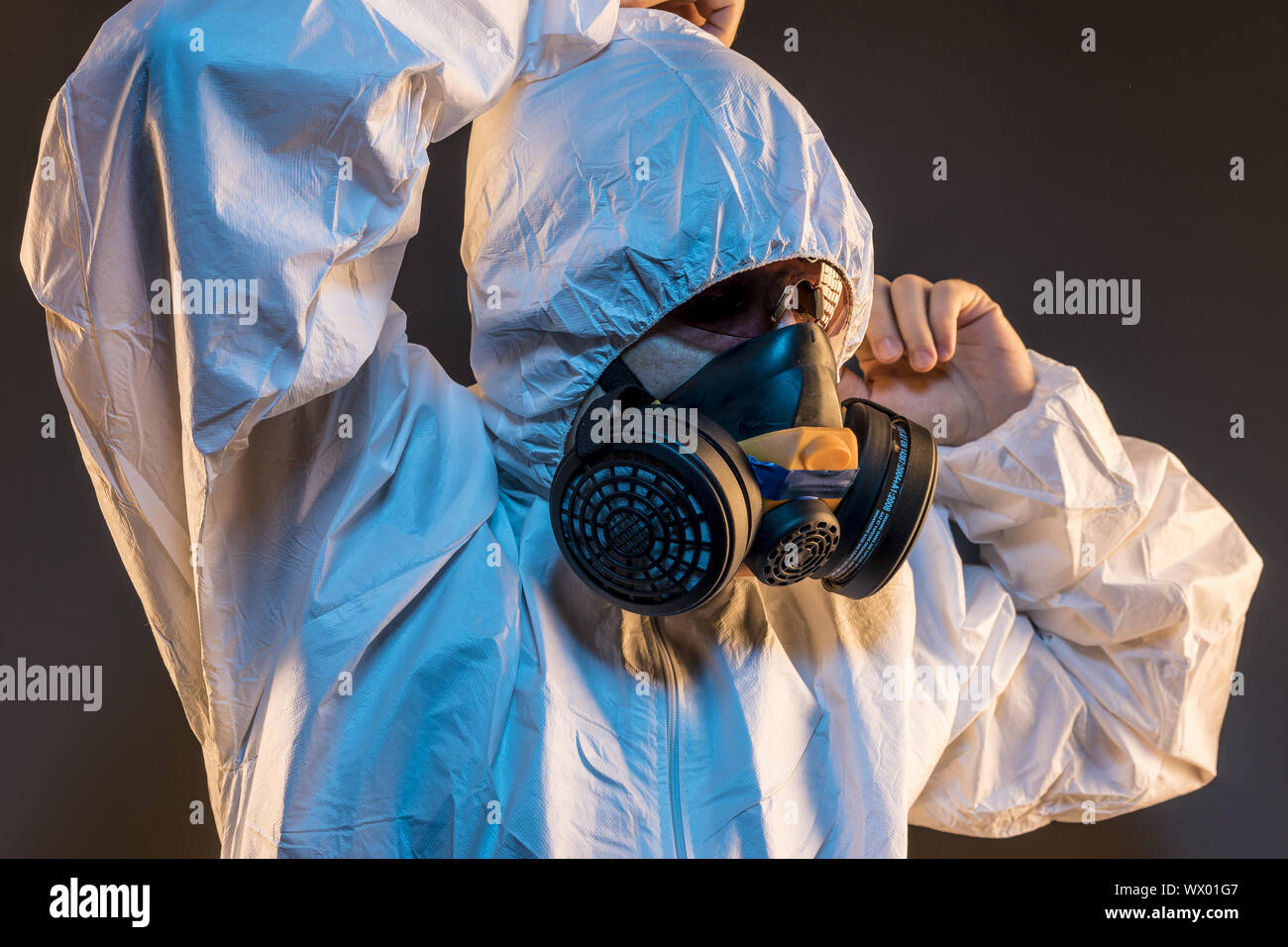 Contagious virus infection concept. Man in protective suit and antigas ...