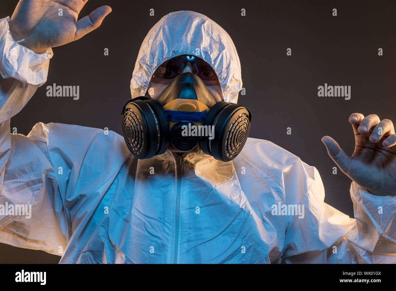 virus infection concept. Man in protective suit and antigas mask with ...