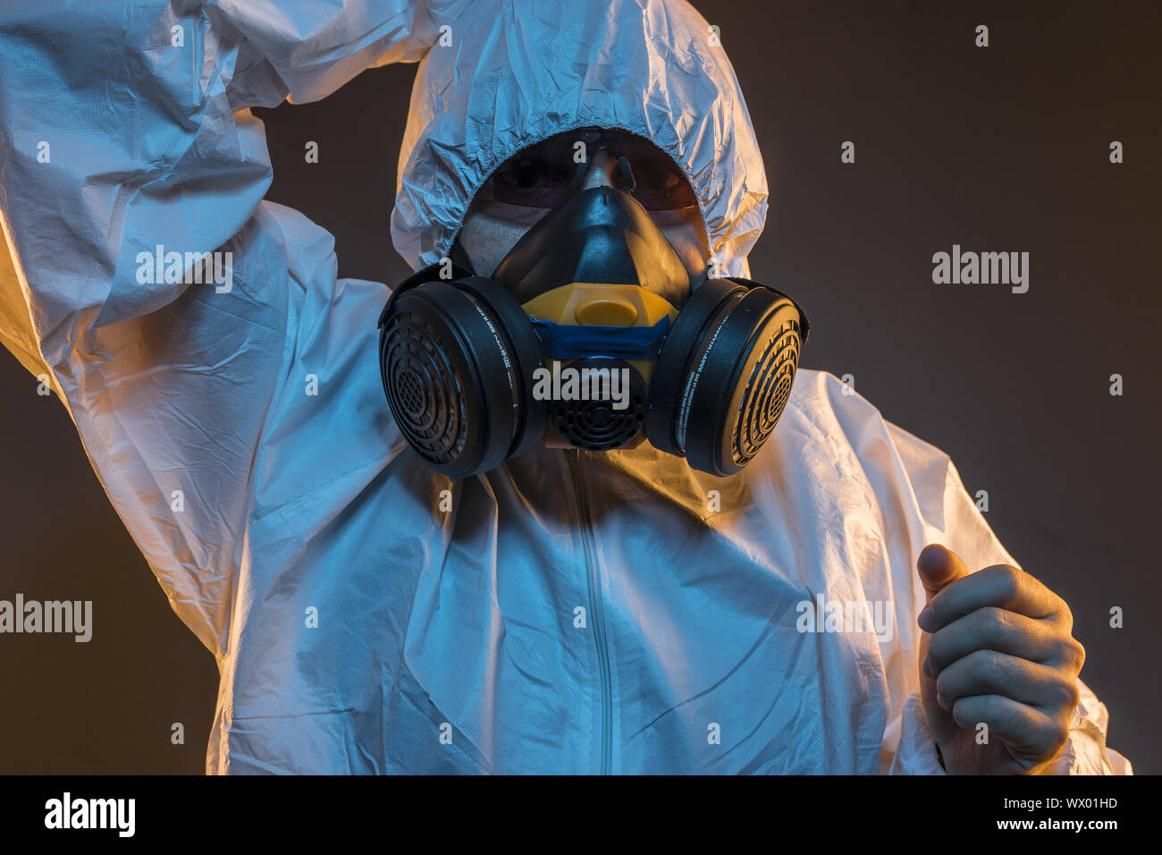 virus infection concept. Man in protective suit and antigas mask with ...