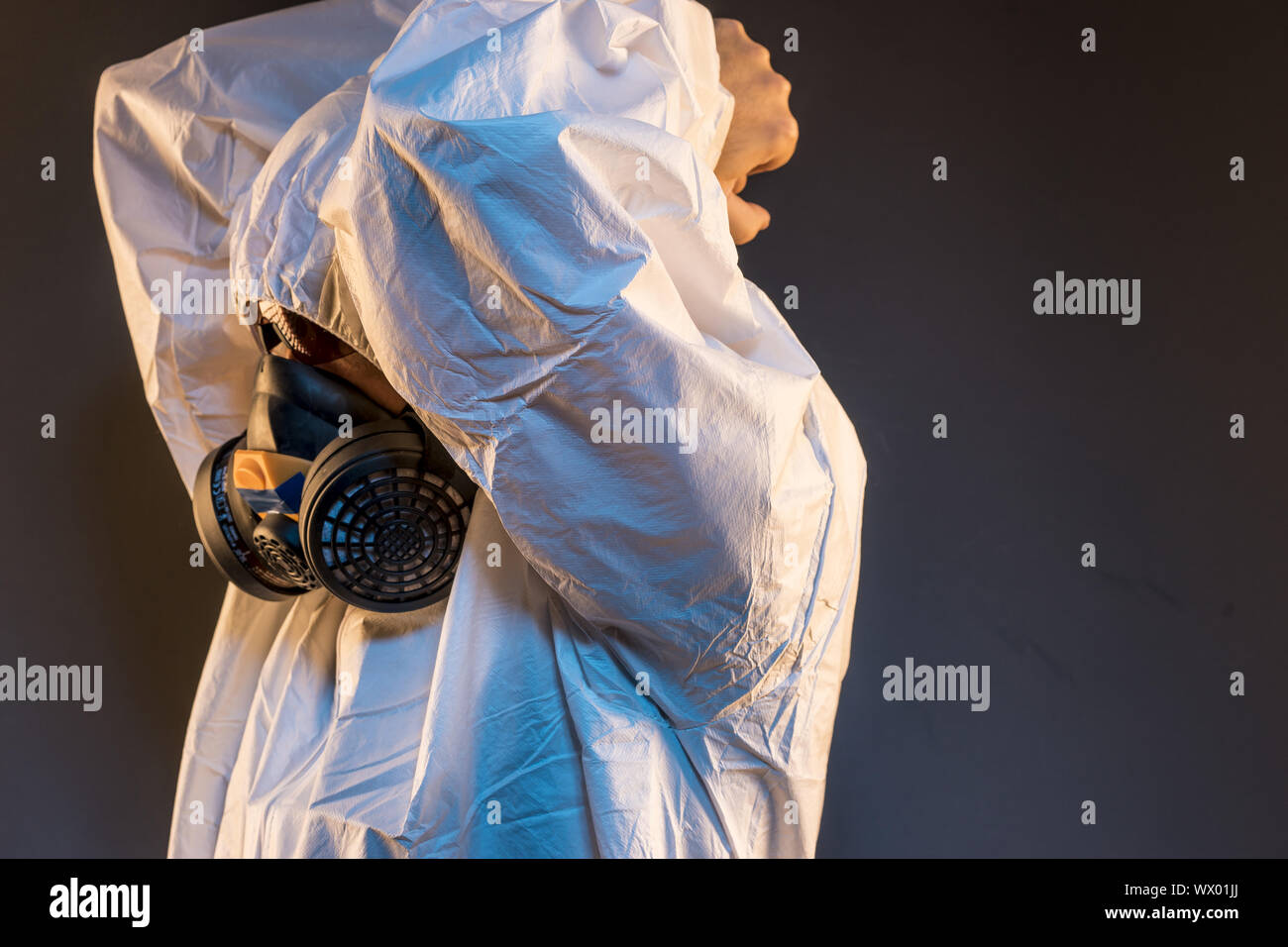Safety virus infection concept. Man in protective suit and antigas mask ...