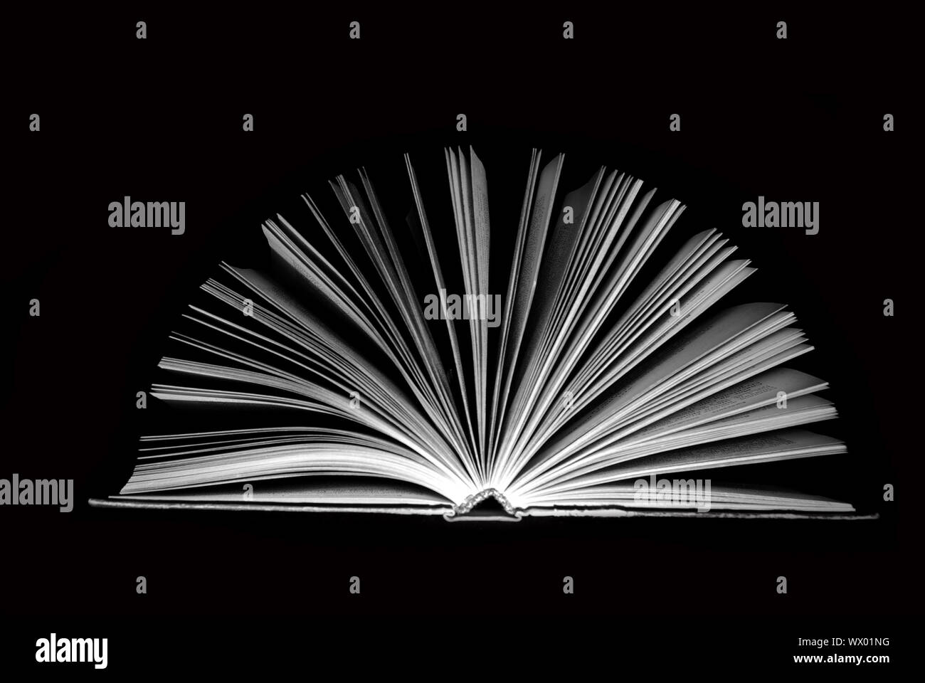 open book on black background Stock Photo - Alamy