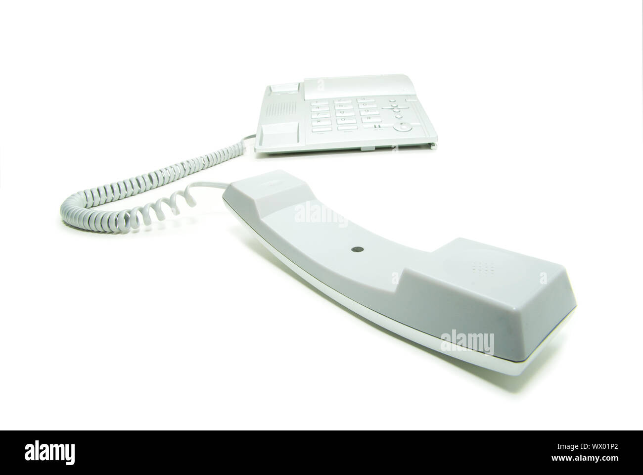 grey office telephone on a white background Stock Photo - Alamy