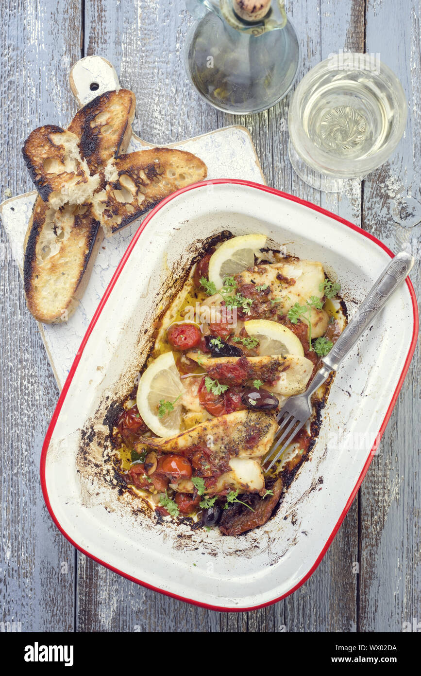 Fried John Dory fish fillet with vegetable and baguette as top-view in ...