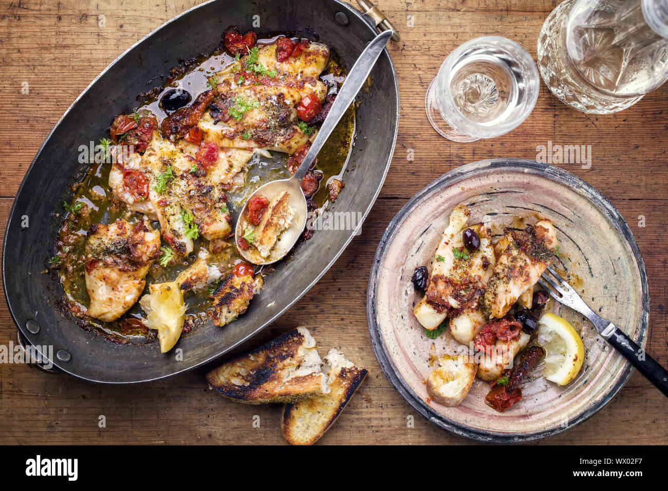 Fried John Dory fish fillet with vegetable and baguette as top-view in ...