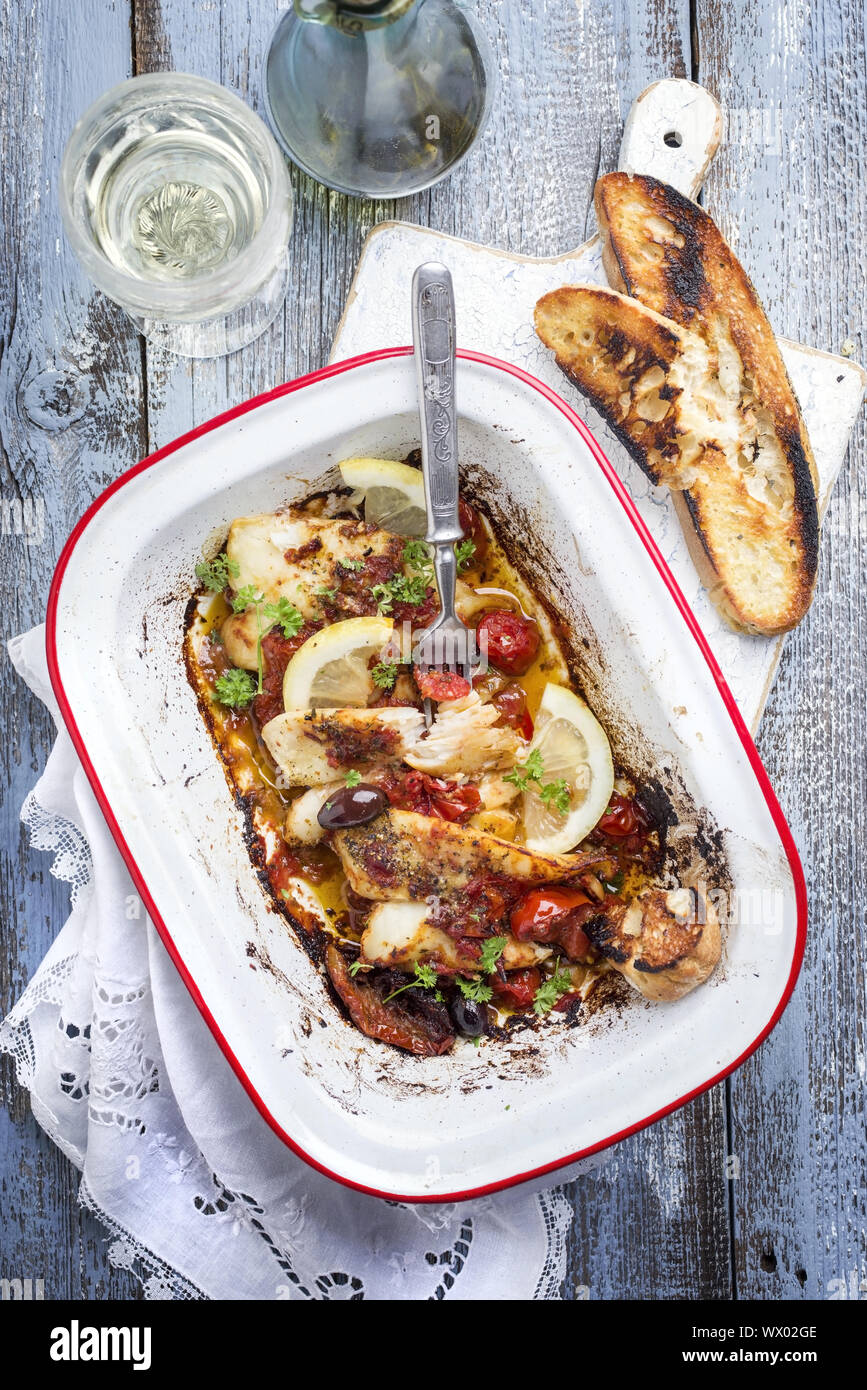 Fried John Dory fish fillet with vegetable and baguette as top-view in ...