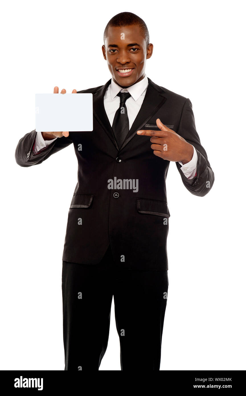 Business promoter pointing at blank placard looking right into camera ...