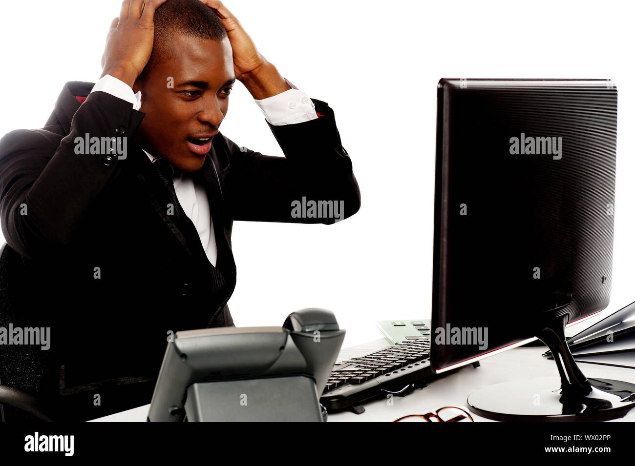 Irritated african man angry on computer at work Stock Photo - Alamy