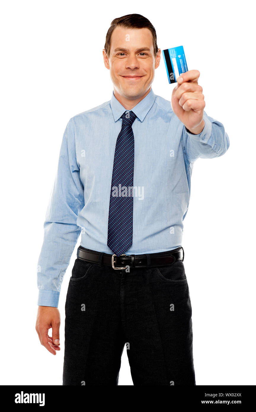 Smiling executive showing credit card isolated against white background ...
