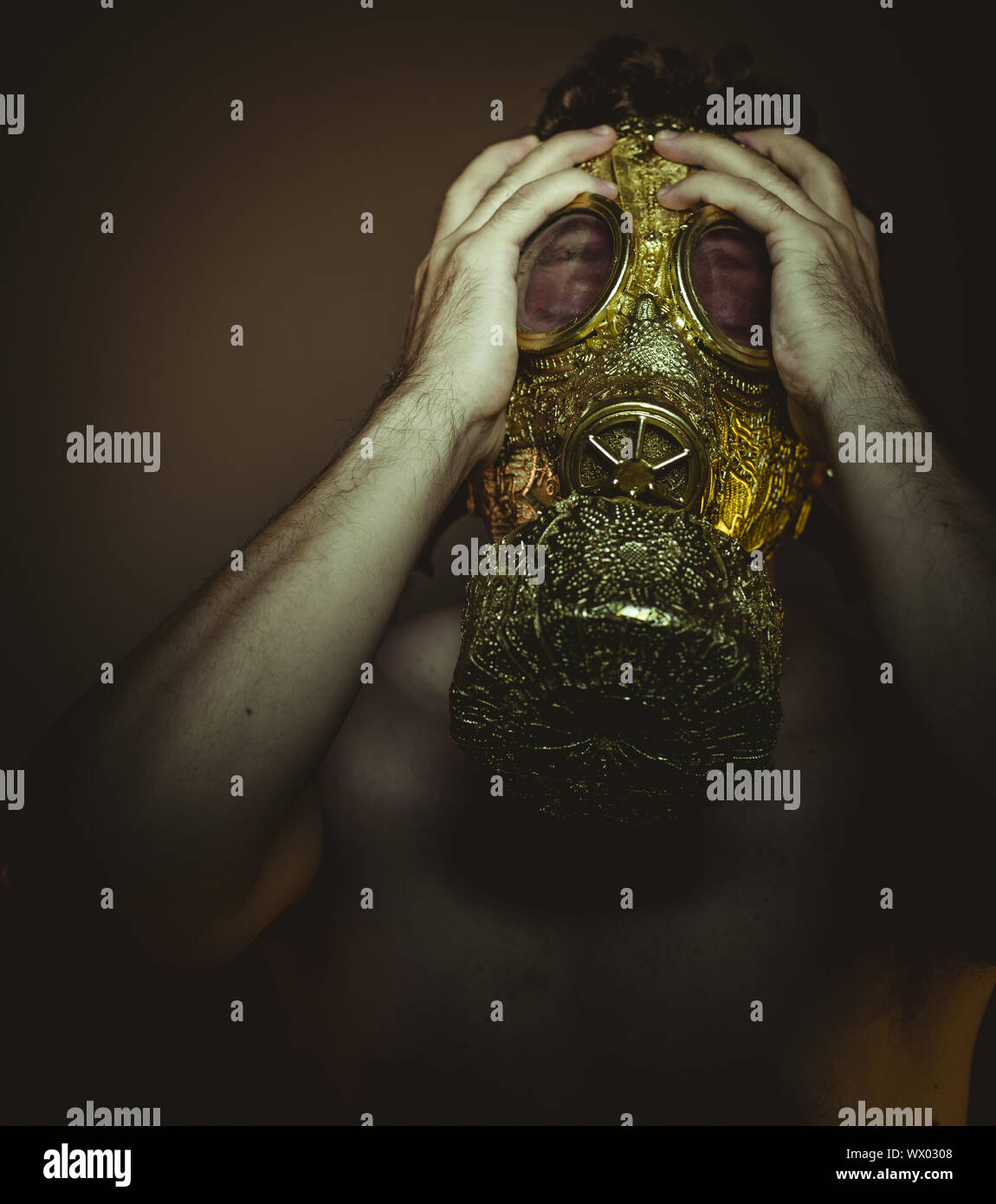 Man with gold gas mask and arabesques in poses of drowning and ...