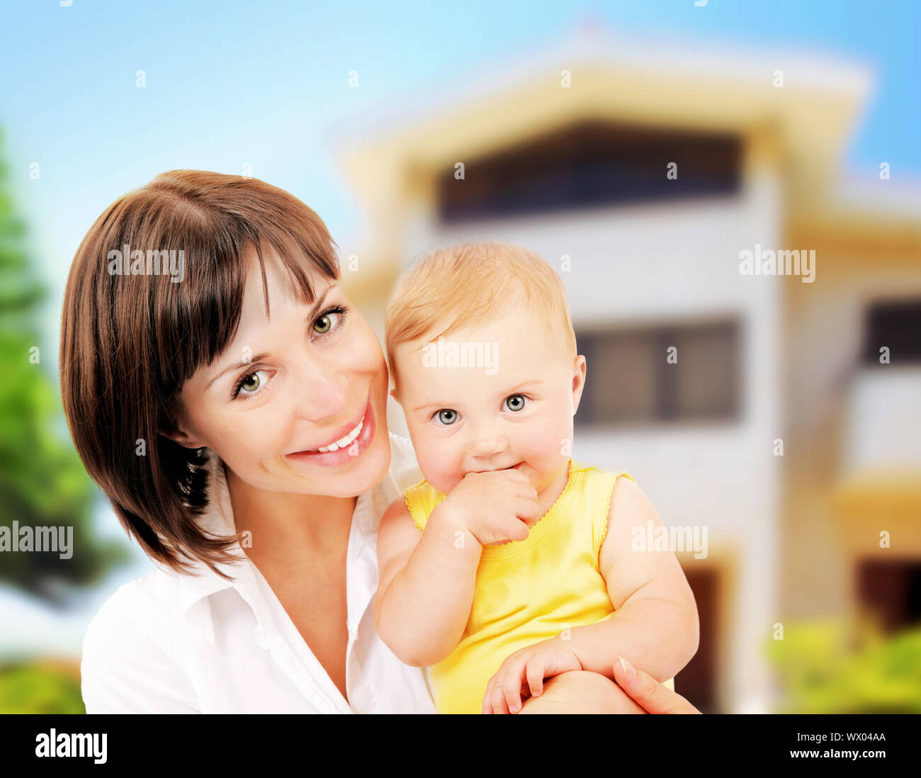 Mother and baby outdoor portrait, family dreaming of new house, happy ...