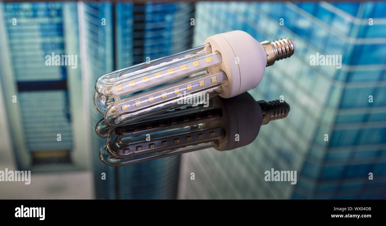 innovation energy saving bulb on black glass. light bulb composed of ...