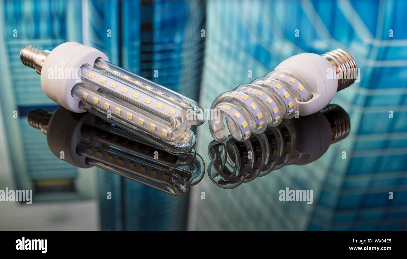 modern, energy saving bulb on black glass. light bulb composed of small ...