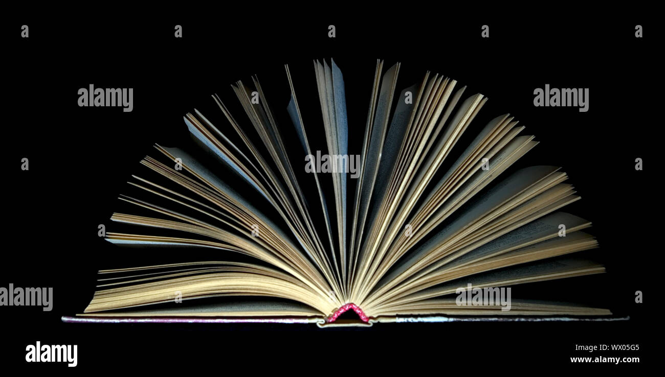 open book on black background Stock Photo - Alamy