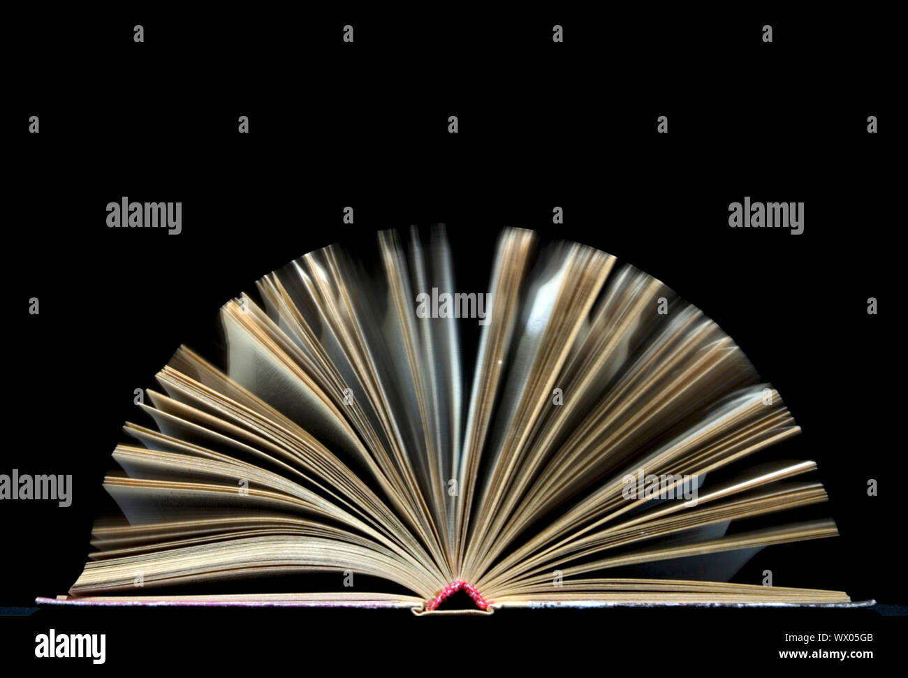 open book on black background Stock Photo - Alamy