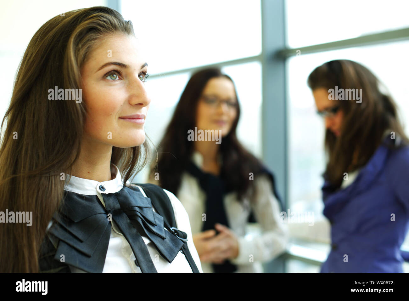 Student meeting smiley girl face on foreground Stock Photo - Alamy