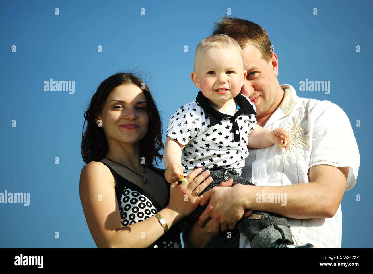 happy family blue sky on background Stock Photo - Alamy
