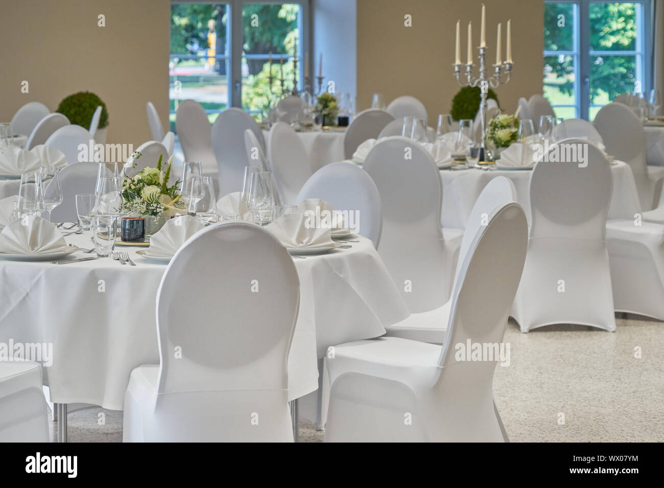 Room with festively bright tables covered in white Stock Photo - Alamy