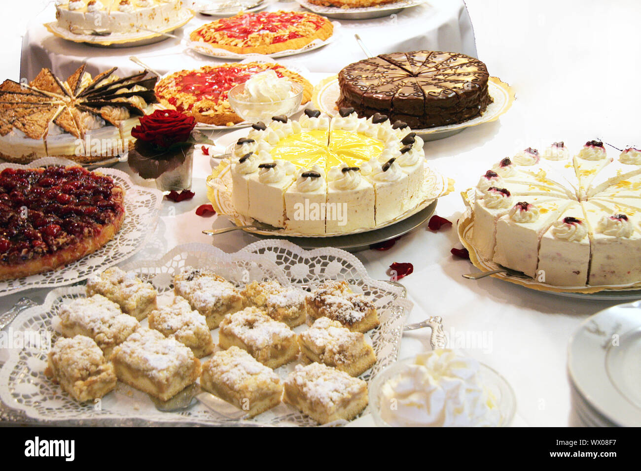 Cake buffet with various cakes decorated with flowers Stock Photo - Alamy