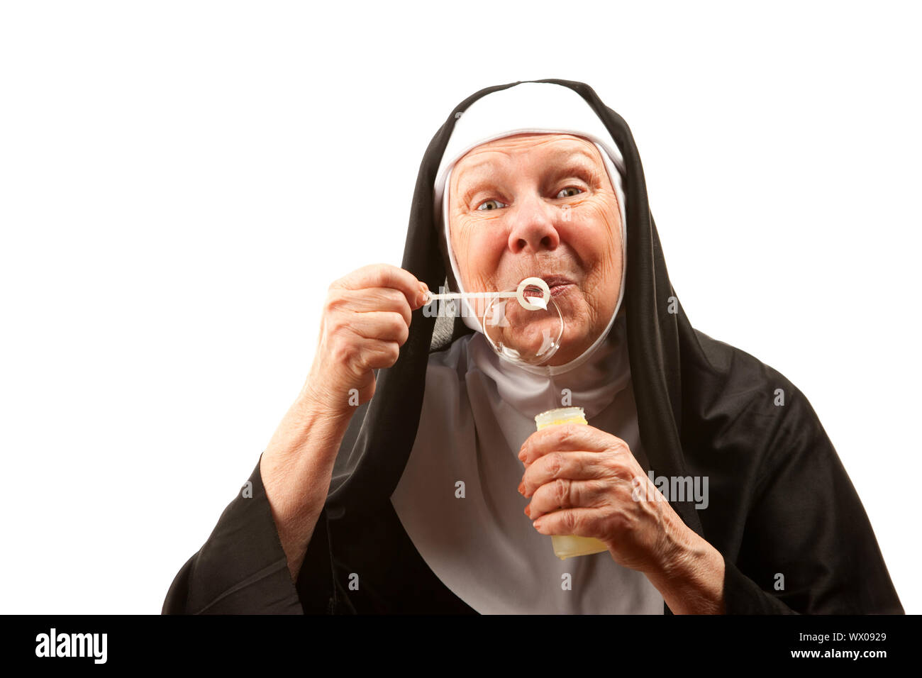 Funney Nun in Religious Habit and Veil Blowing Bubbles Stock Photo - Alamy