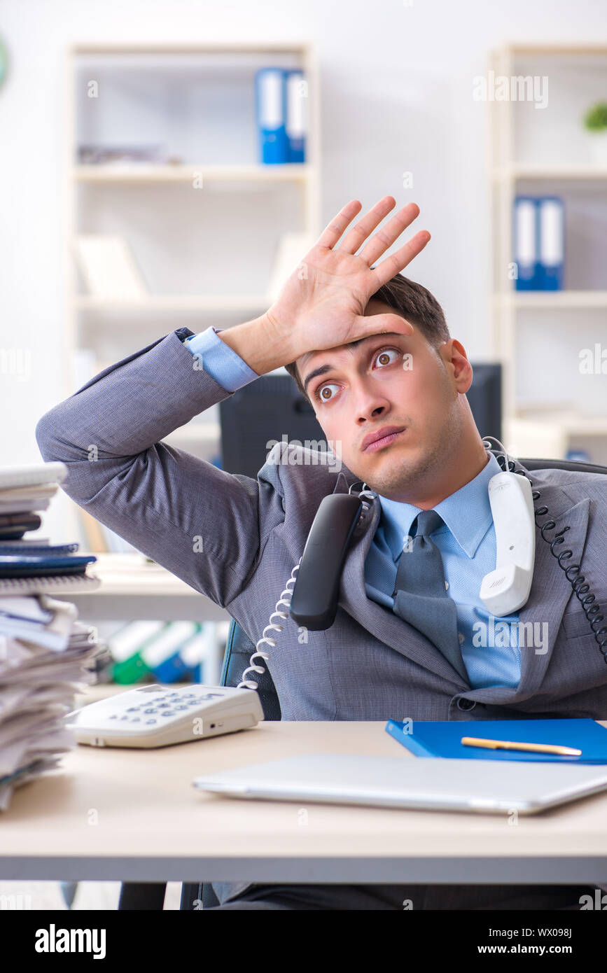 Desperate sad employee tired at his desk in call center Stock Photo - Alamy