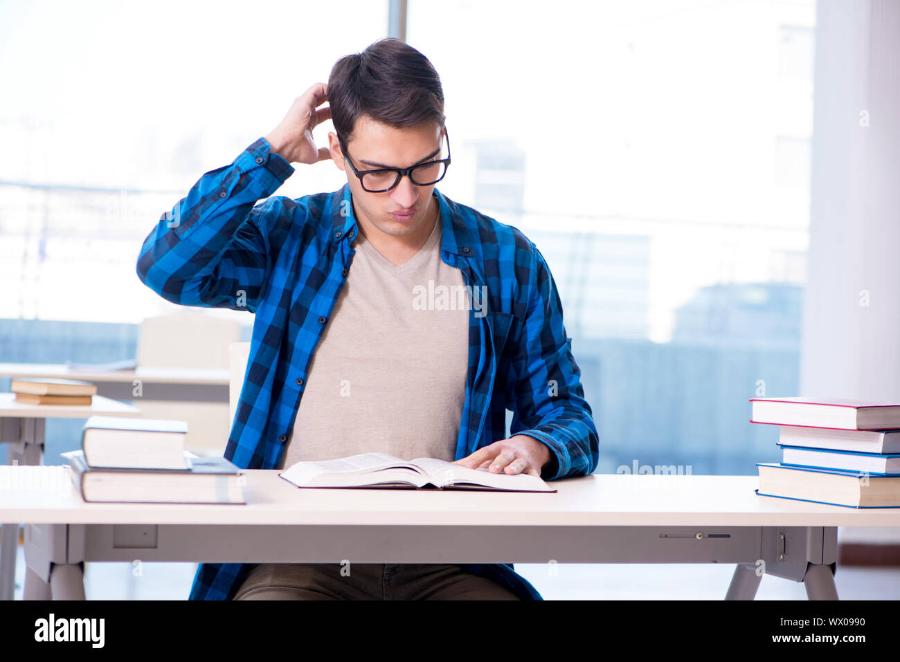 Student studying in the empty library with book preparing for ex Stock ...
