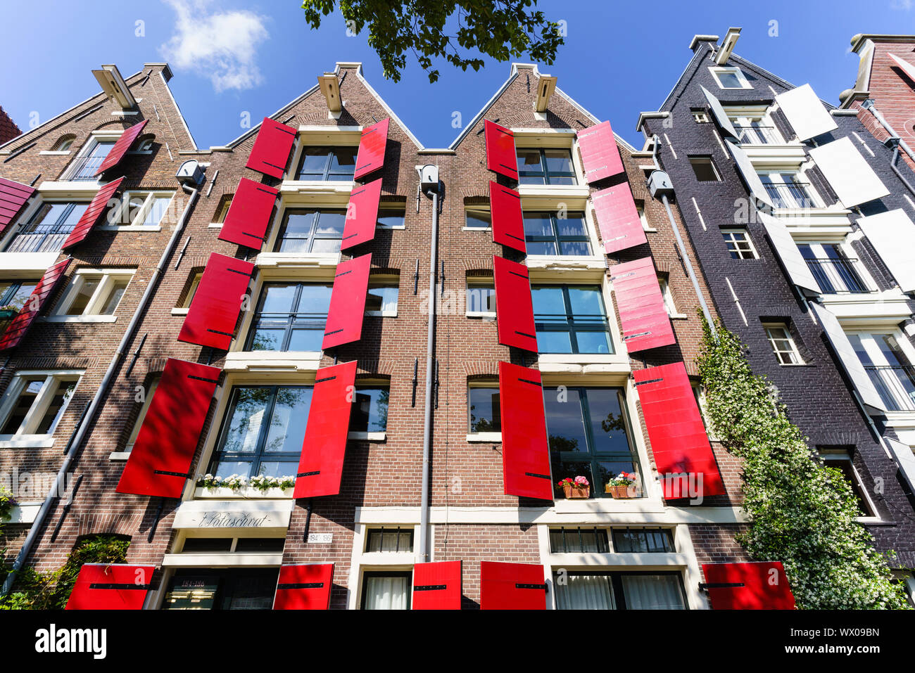 Red shutters on traditional Dutch style building, Amsterdam, North ...