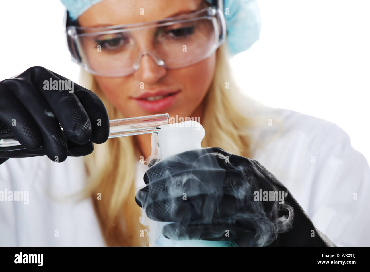 Woman conducting a chemical experiment Stock Photo - Alamy
