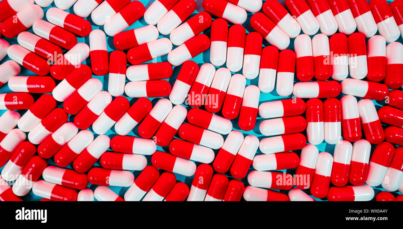Many red-white pills or drugs colorful background. Medicine healthy ...