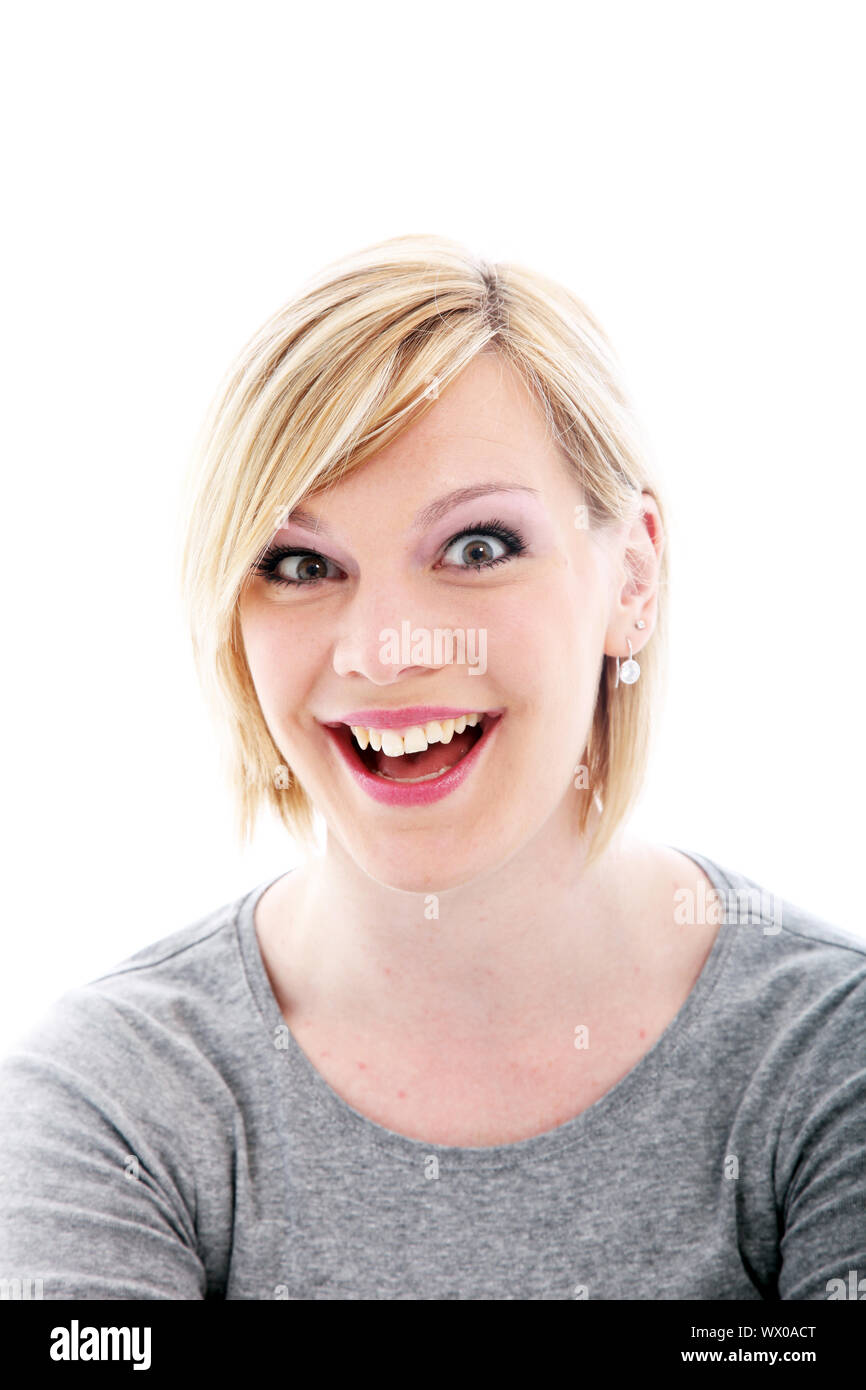 Exuberant young woman with an animated expression and wide beaming ...