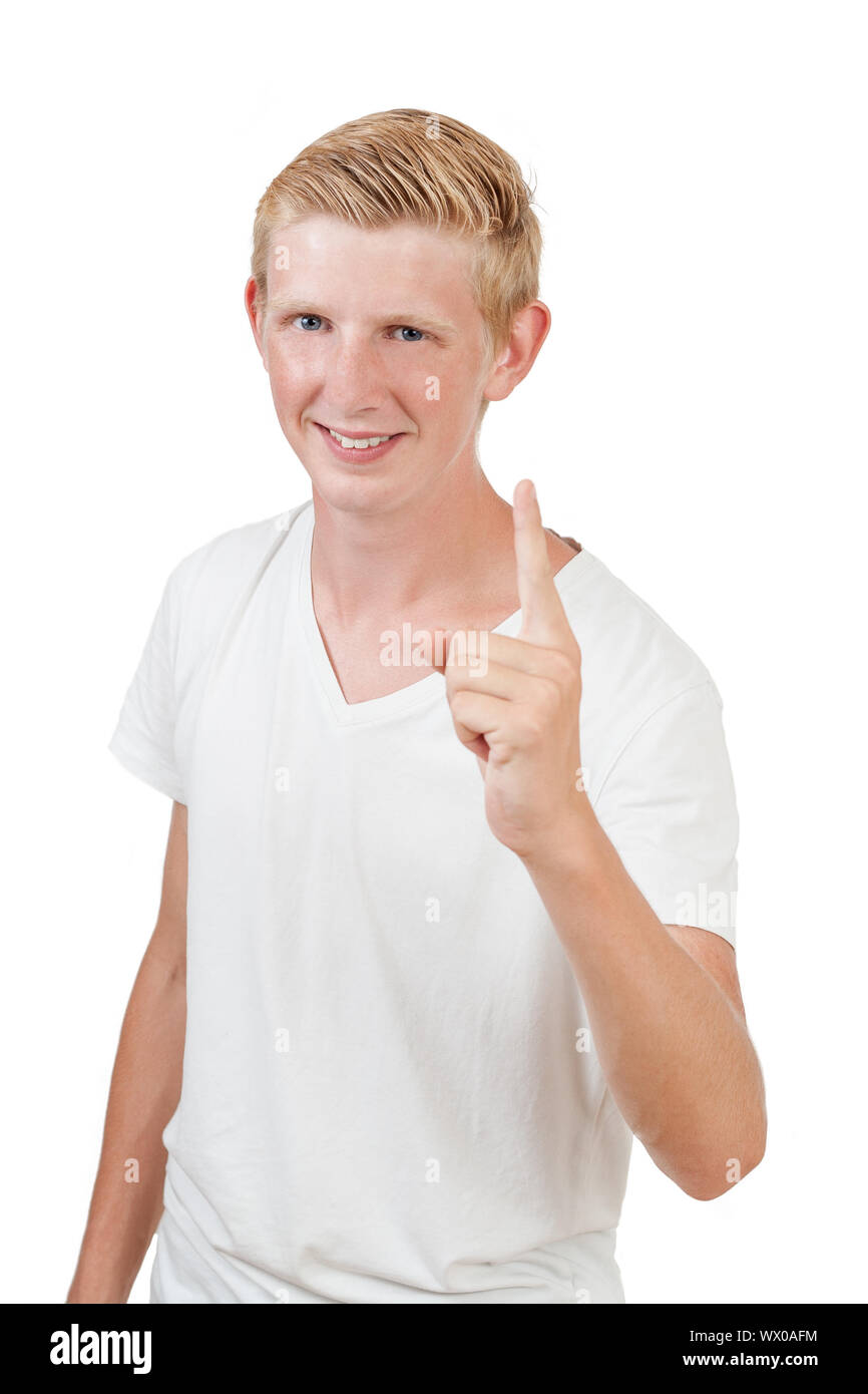 Portrait of a handsome young man pointing finger up against white ...