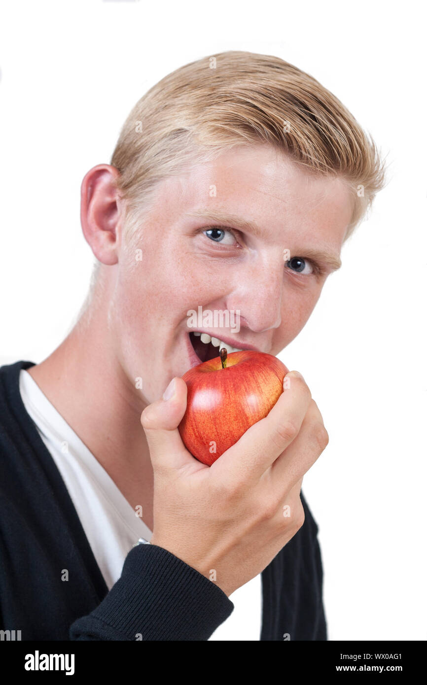 Young healthy man eating a red apple on white background Stock Photo ...